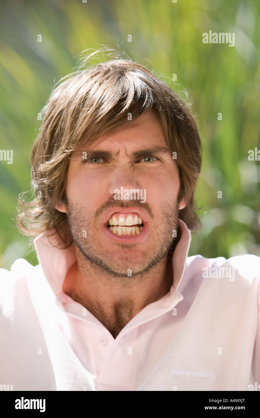 Man baring his teeth Stock Photo - Alamy