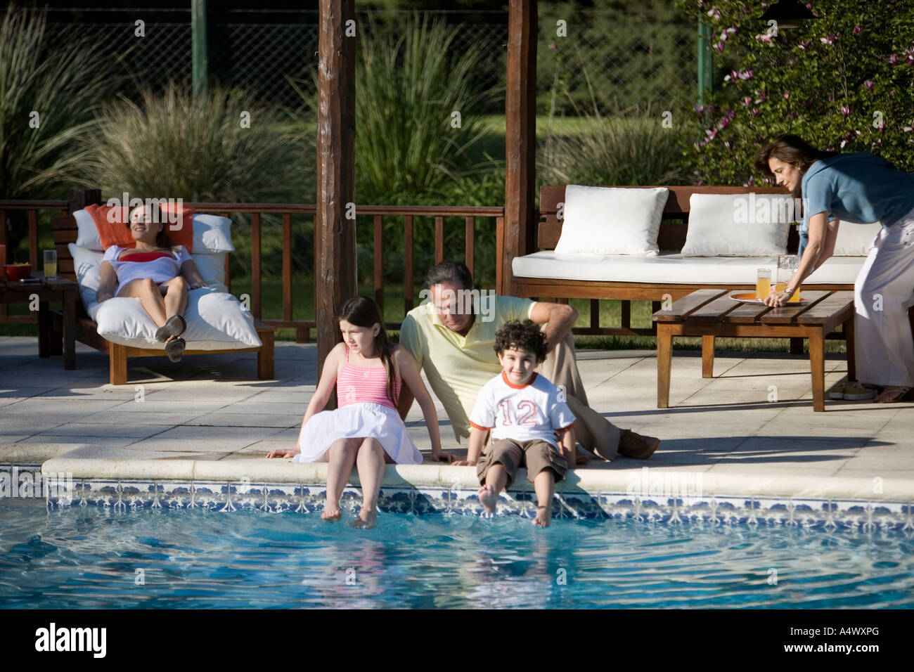 Family at the pool hi-res stock photography and images - Alamy
