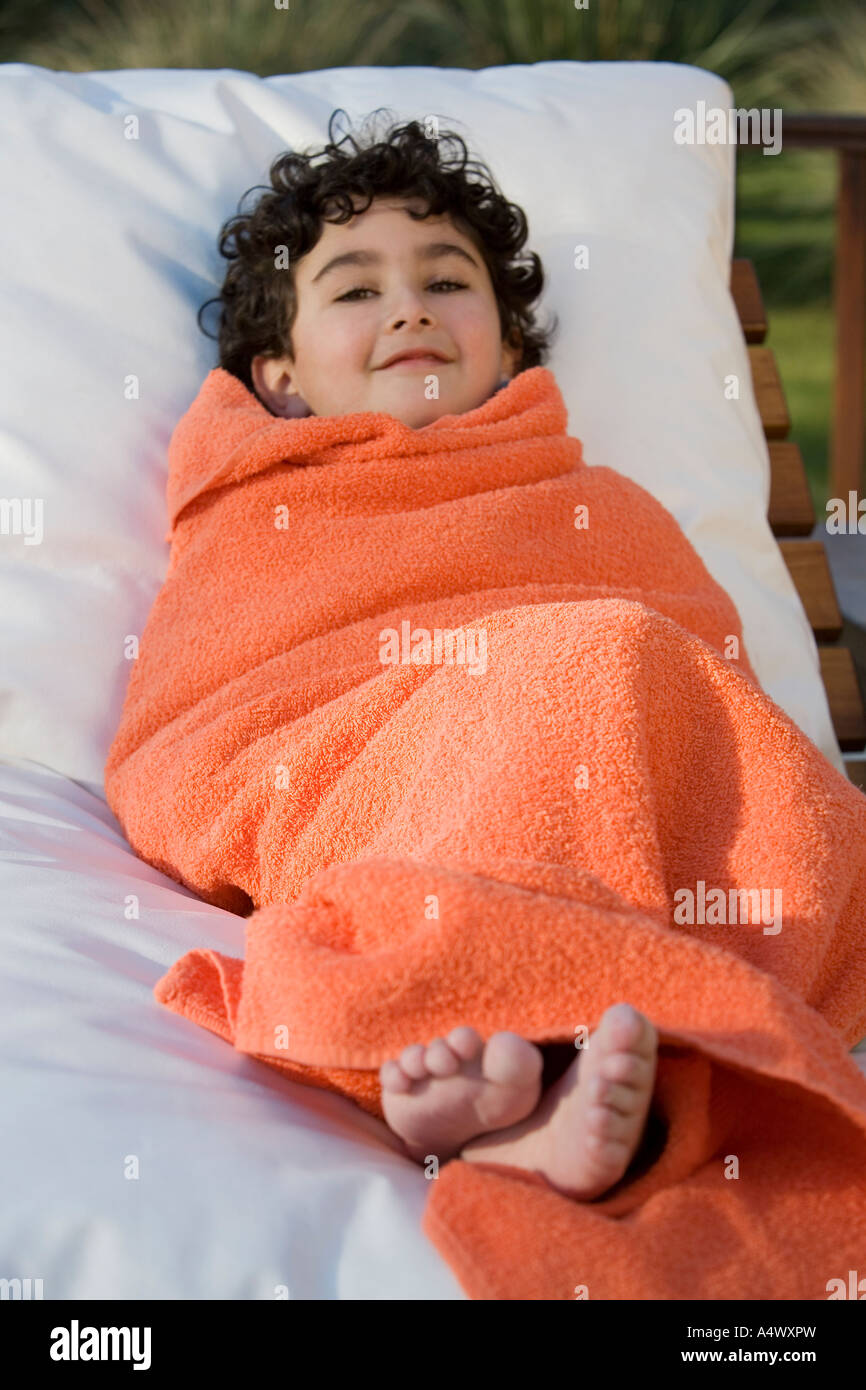 Young boy wrapped in a towel Stock Photo - Alamy