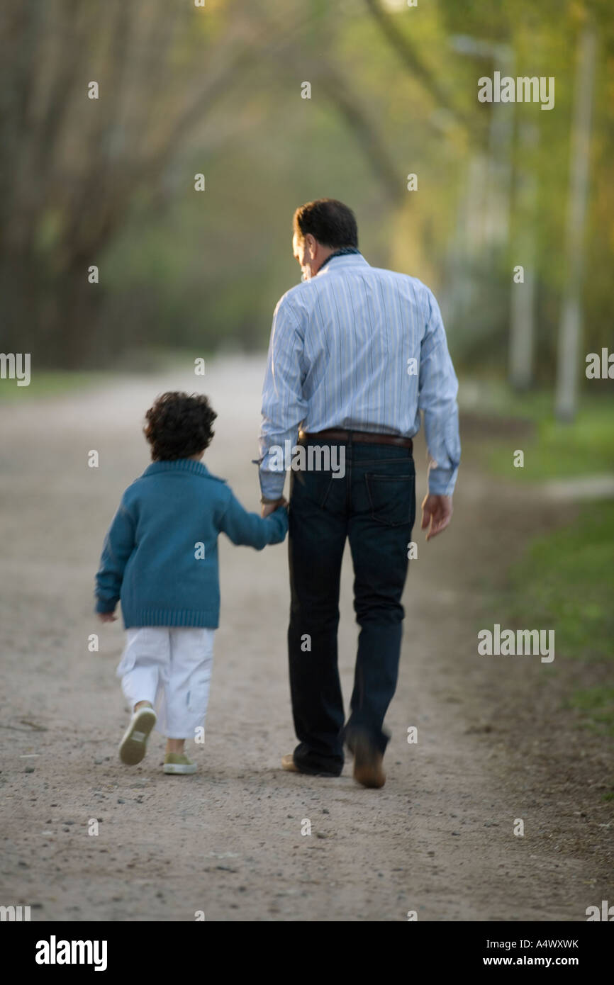 Father and son walking together outdoors Stock Photo - Alamy