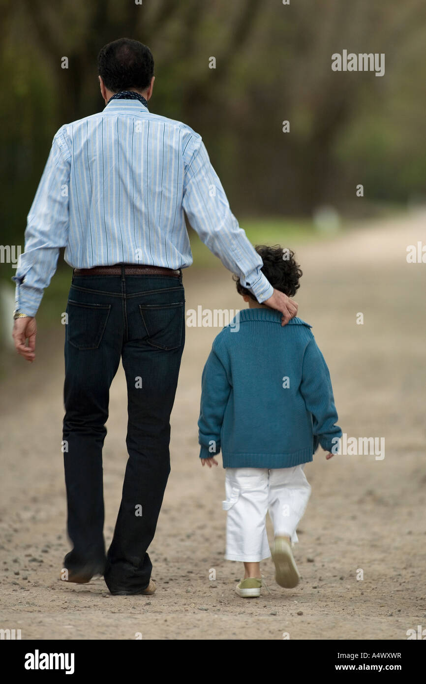 Father and son walking together outdoors Stock Photo - Alamy