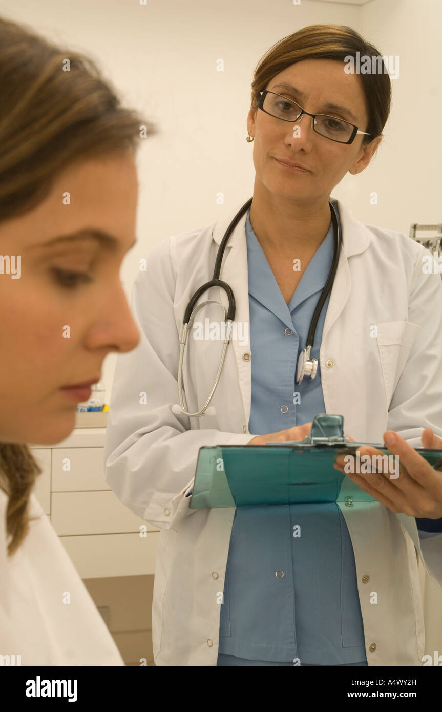 Female doctor talking to patient Stock Photo - Alamy