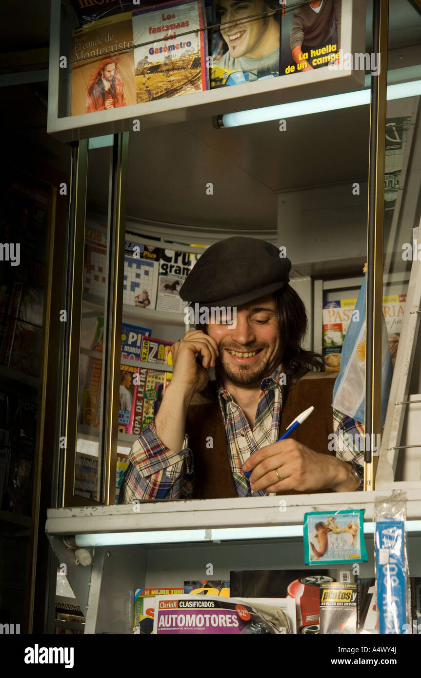 Man talking on his cell phone while staffing newspaper stand Stock ...