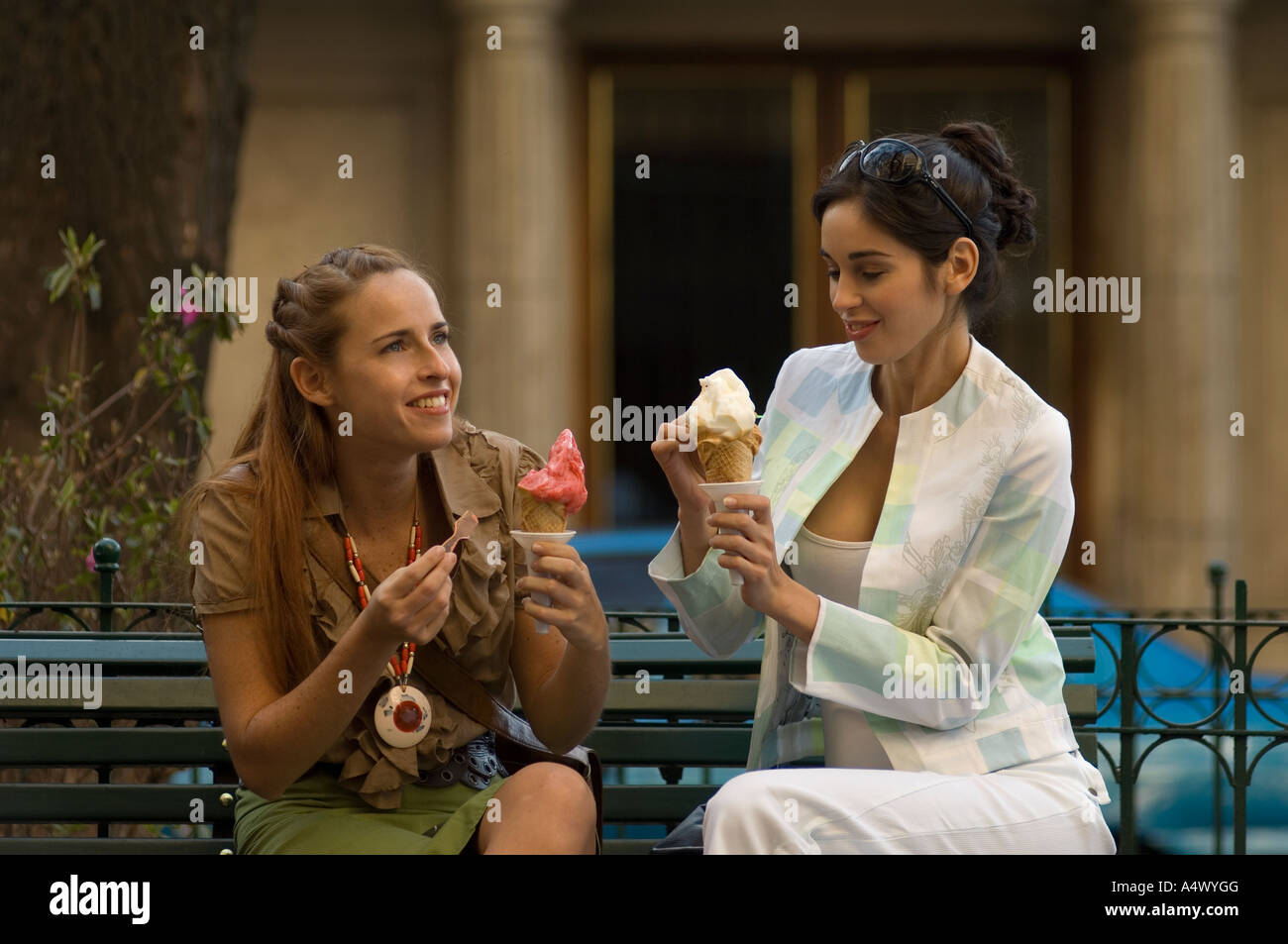 Women eating ice cream in a park Stock Photo - Alamy