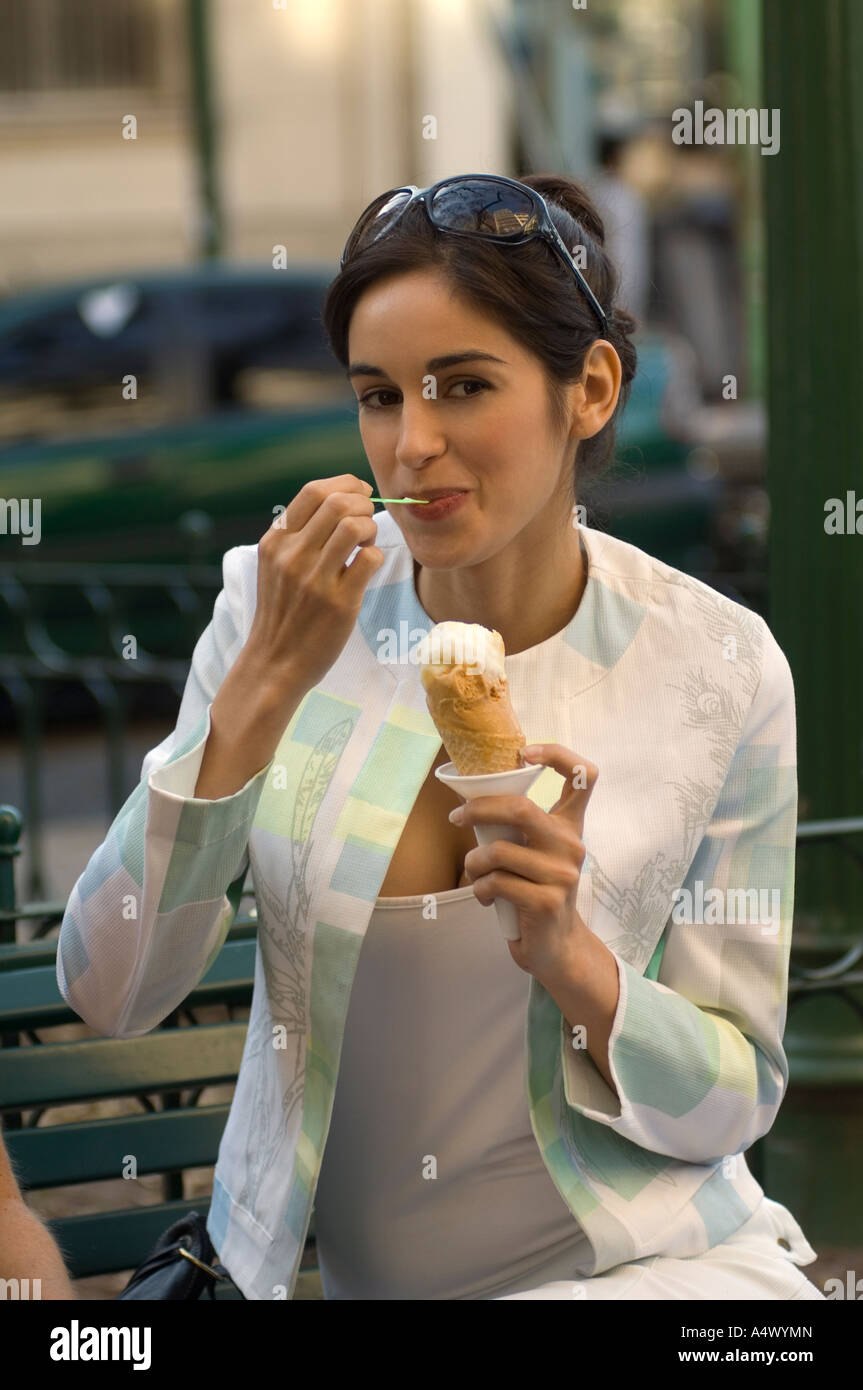 Woman eating ice cream in a park Stock Photo - Alamy