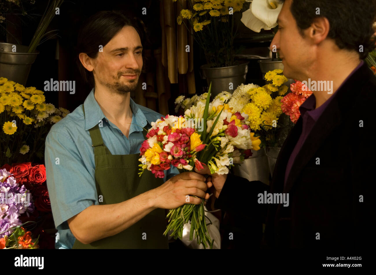 Man selling a bouquet of flowers Stock Photo - Alamy