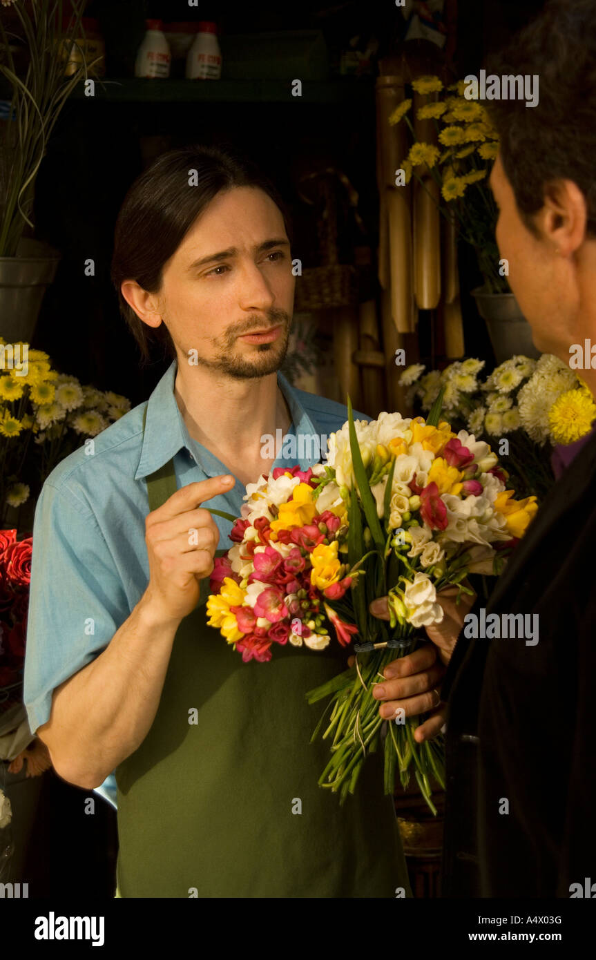 Man selling a bouquet of flowers Stock Photo - Alamy