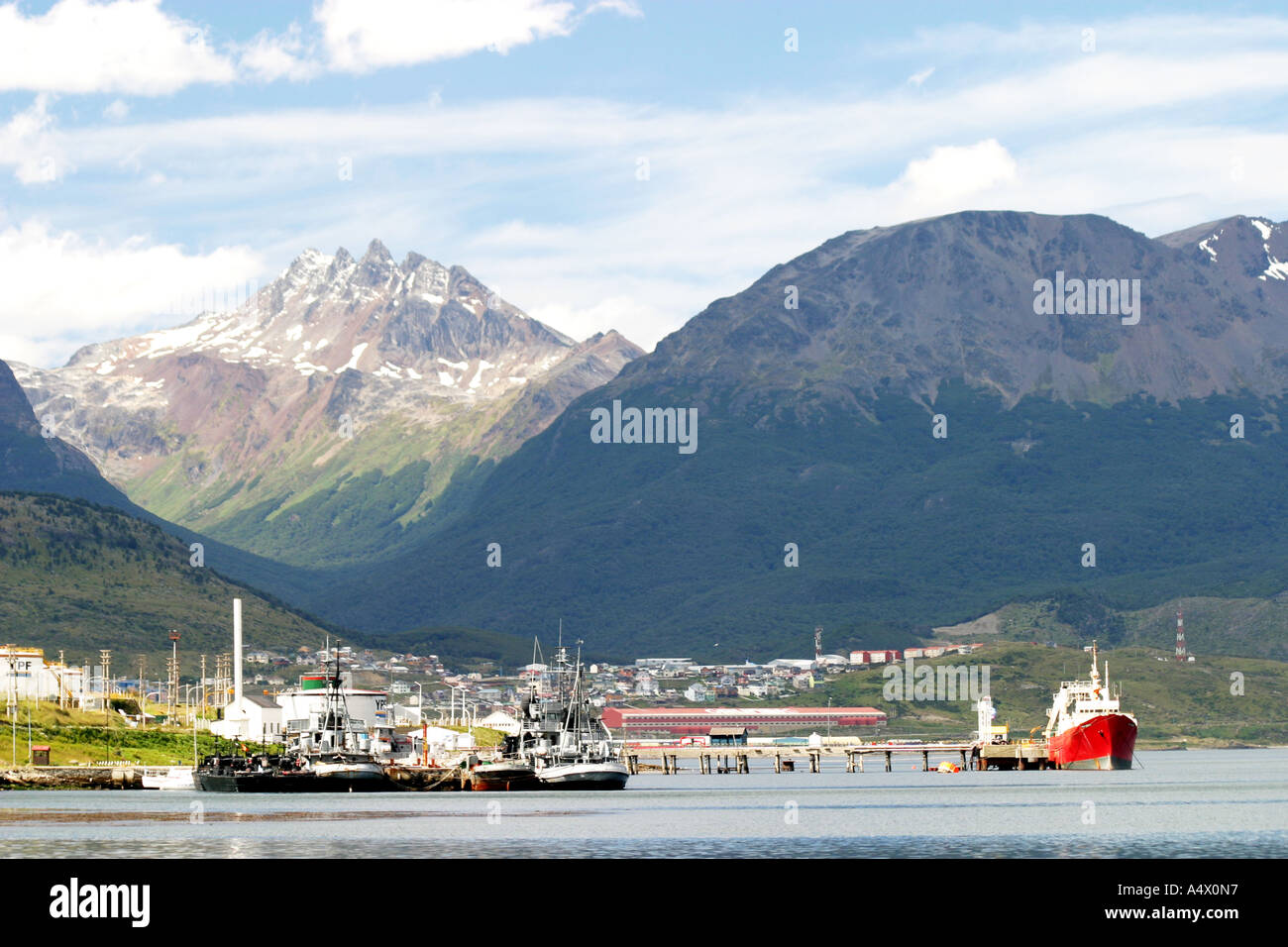 Ship refueling at Usuhaia dock Argentina with the Andes Mountains in ...