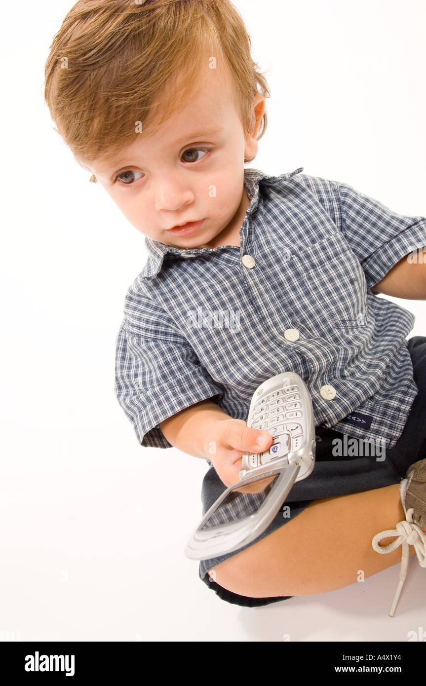 LITTLE BOY USING CELL PHONE Stock Photo - Alamy