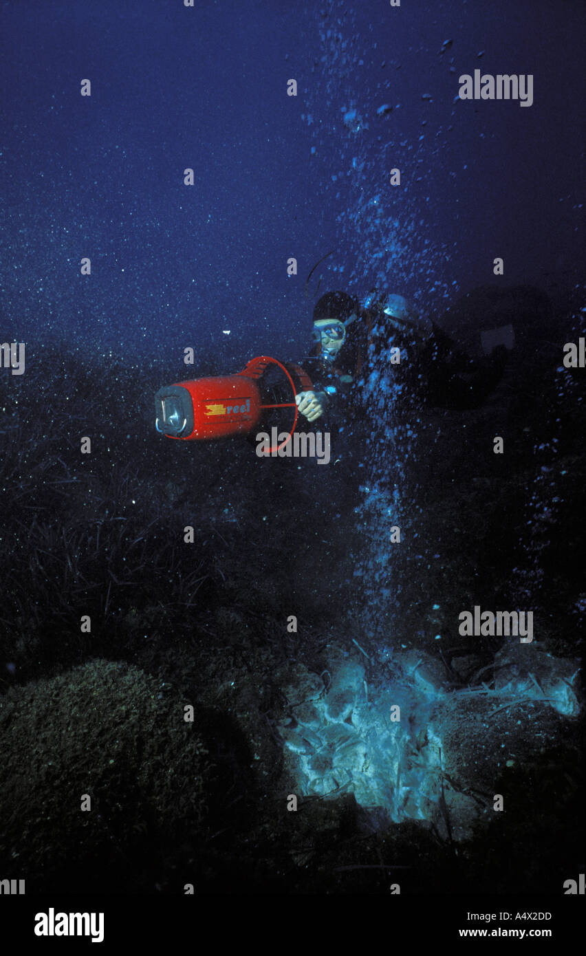 Scuba diver researchers explore the faces of a submerged volcano Stock ...