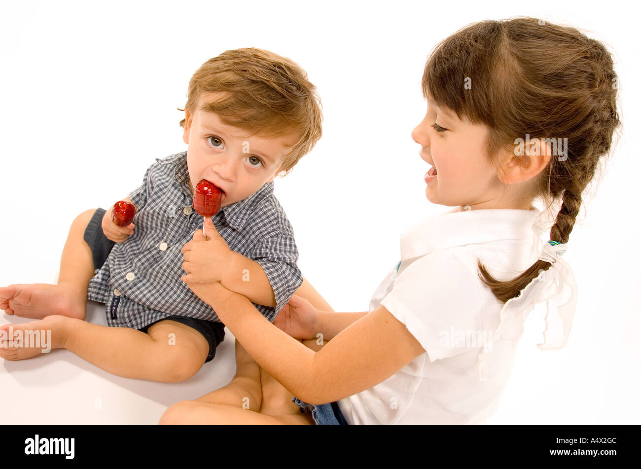 BROTHER AND SISTER SHARING LOLLYPOP Stock Photo - Alamy