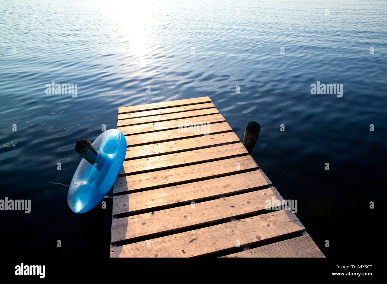 Dock and inner tube on a Lake Stock Photo - Alamy