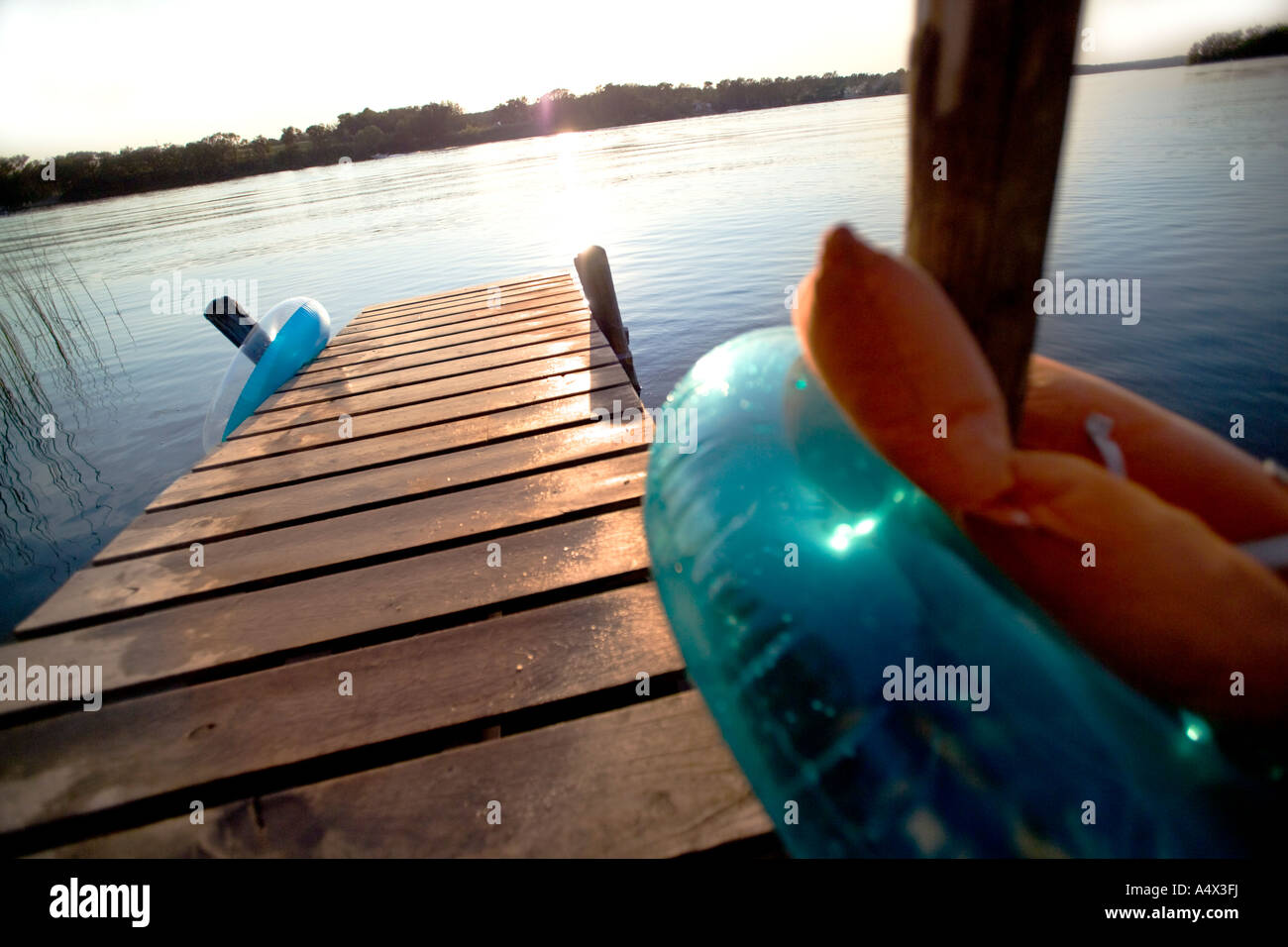 Dock and inner tube on a Lake Stock Photo - Alamy