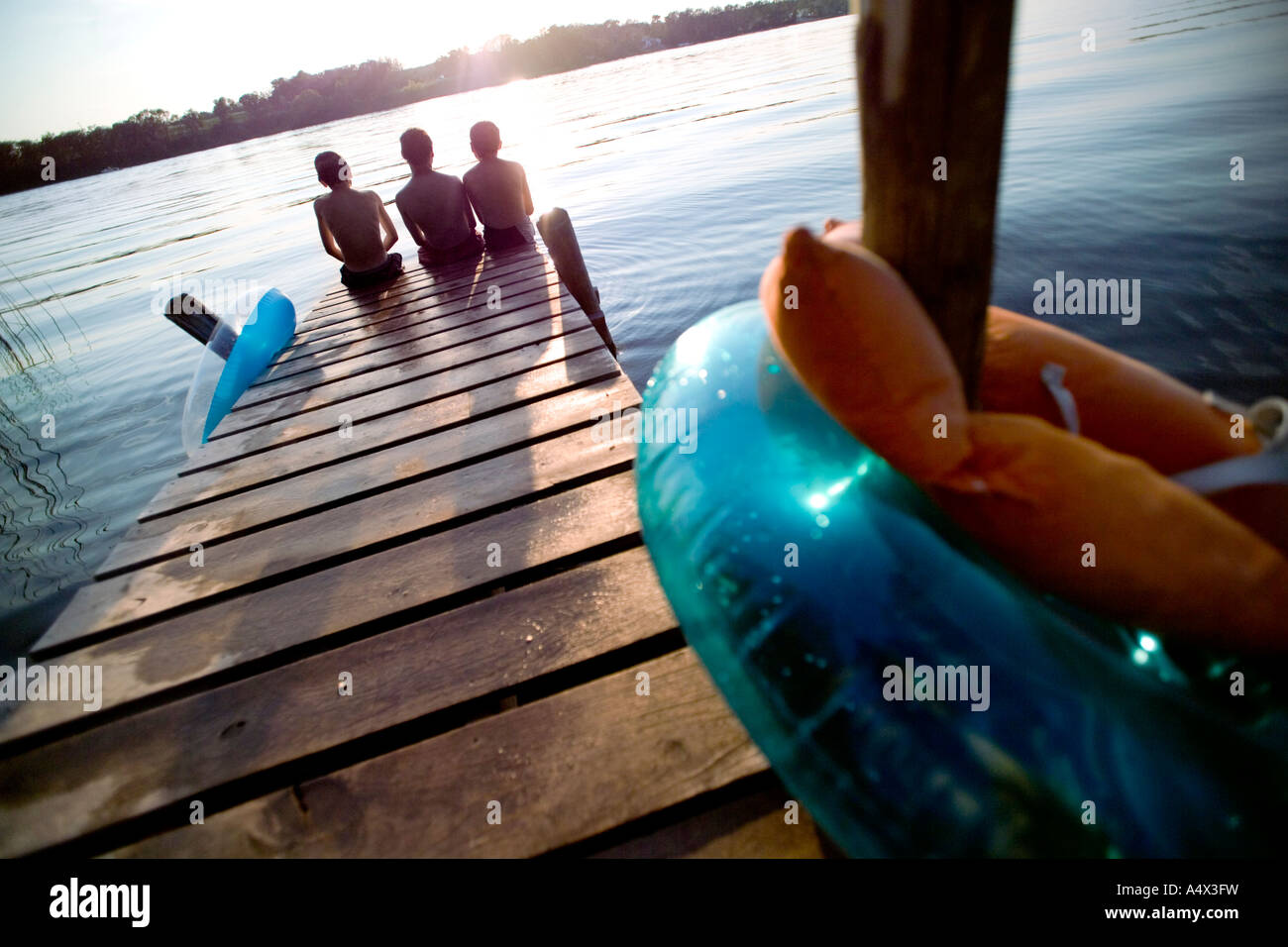 Kids sitting on dock hi-res stock photography and images - Alamy