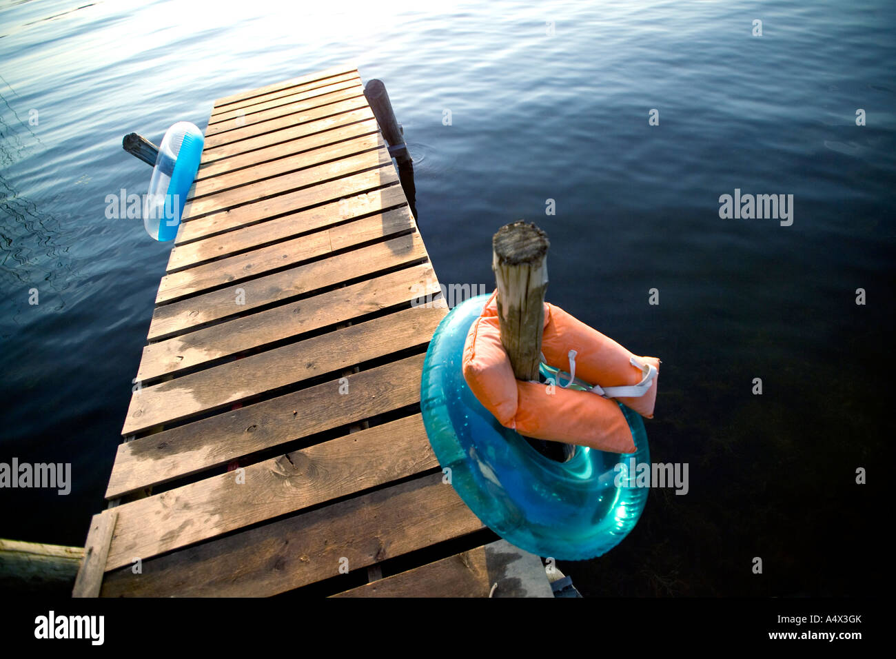 Dock and inner tube on a Lake Stock Photo - Alamy
