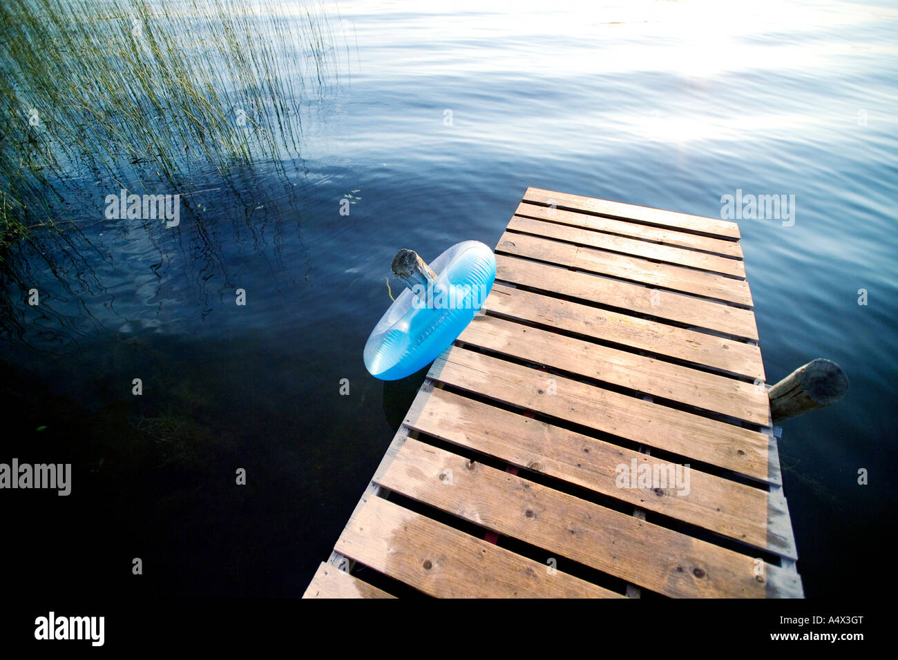Dock and inner tube on a Lake Stock Photo - Alamy