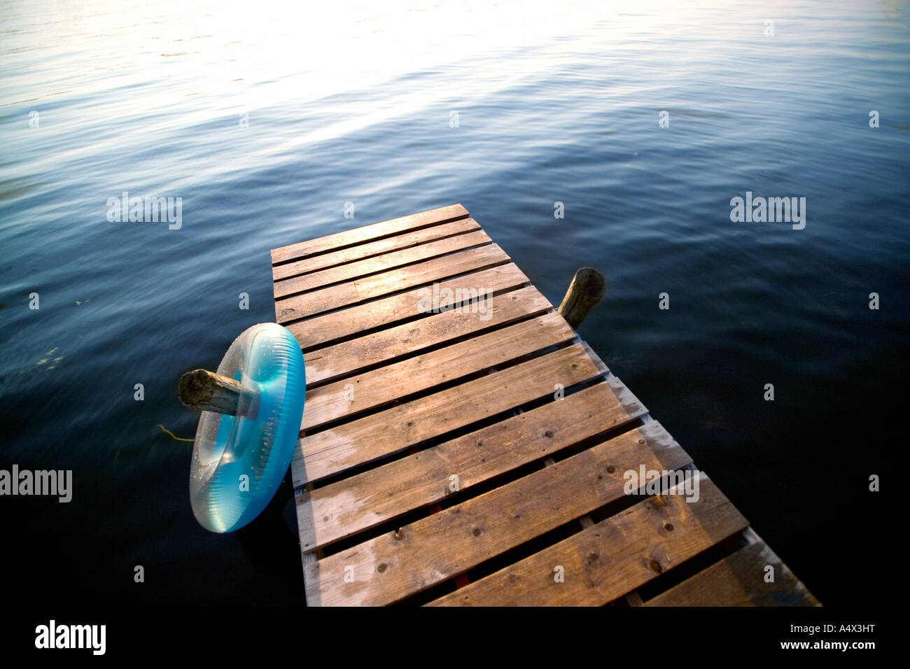 Dock and inner tube on a Lake Stock Photo - Alamy