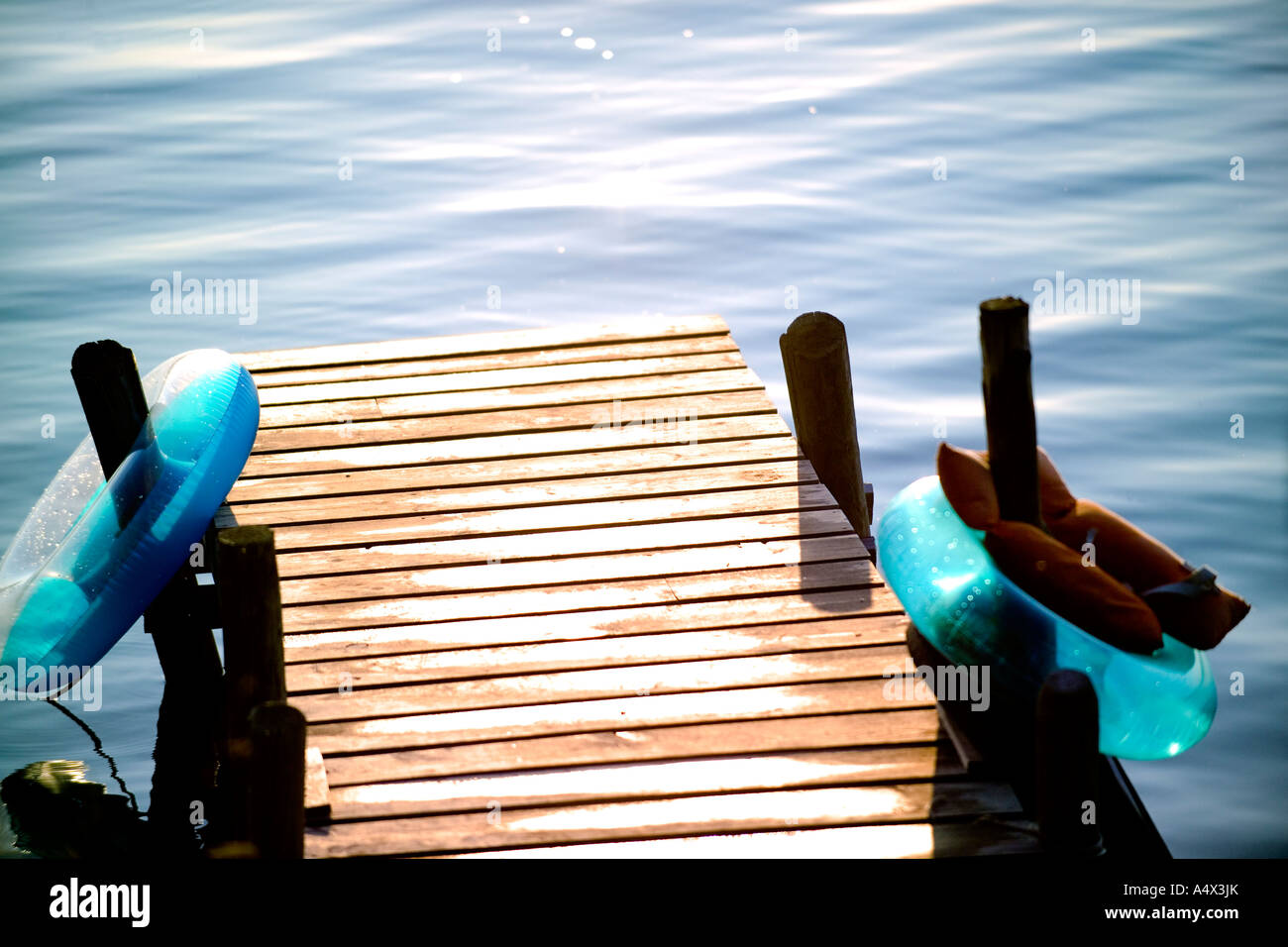 Dock and inner tube on a Lake Stock Photo - Alamy
