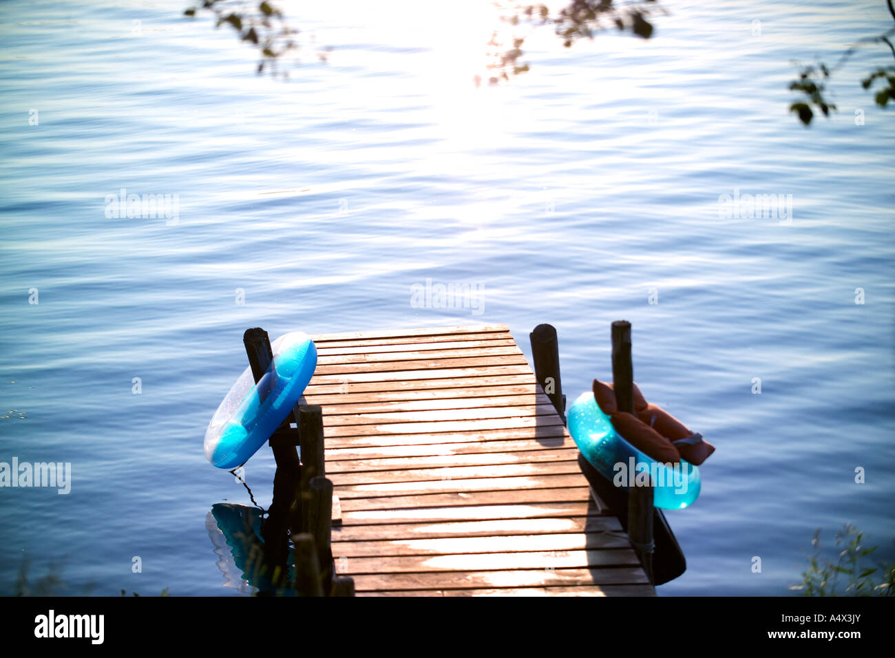 Dock and inner tube on a Lake Stock Photo - Alamy