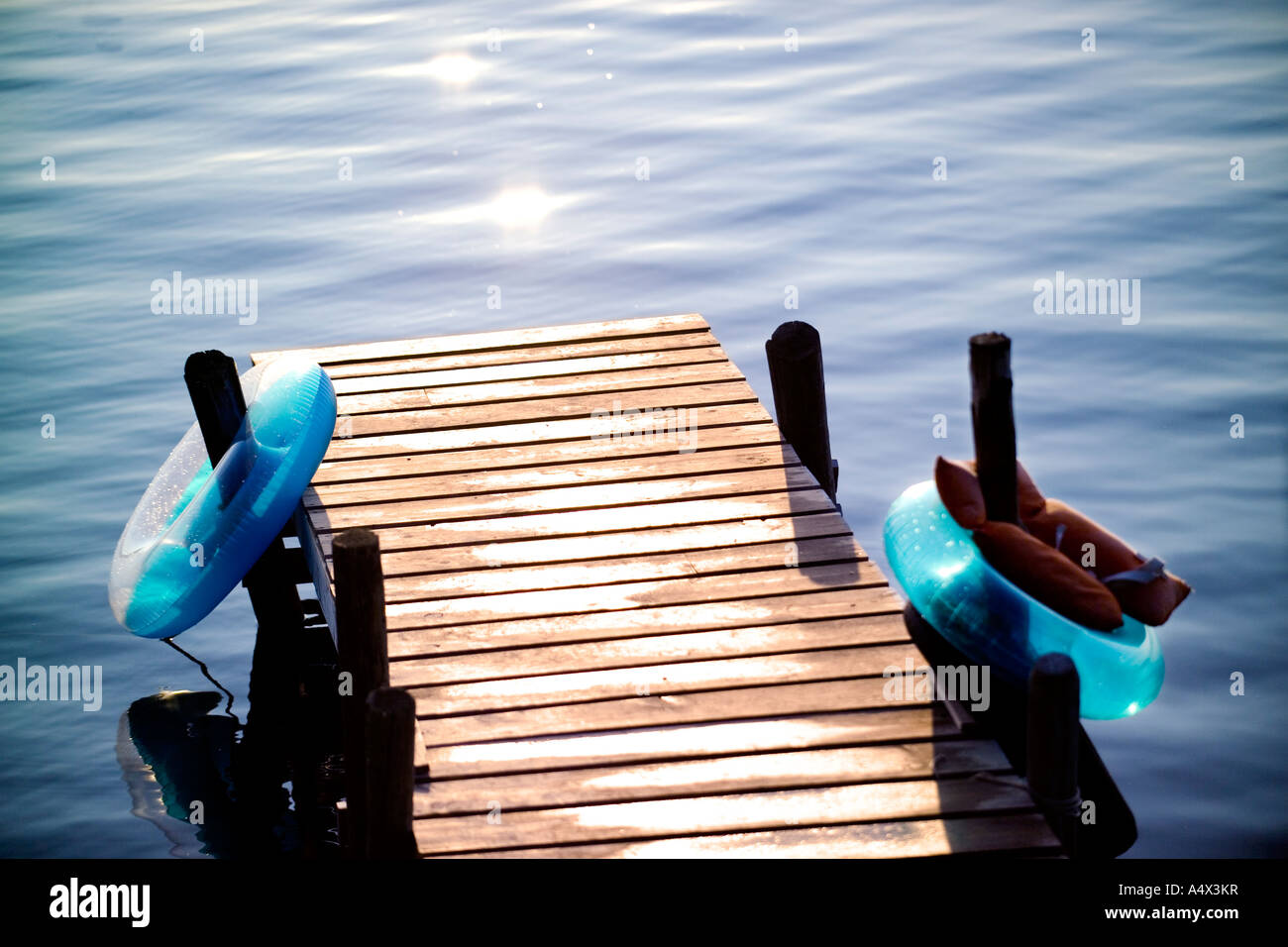 Dock and inner tube on a Lake Stock Photo - Alamy