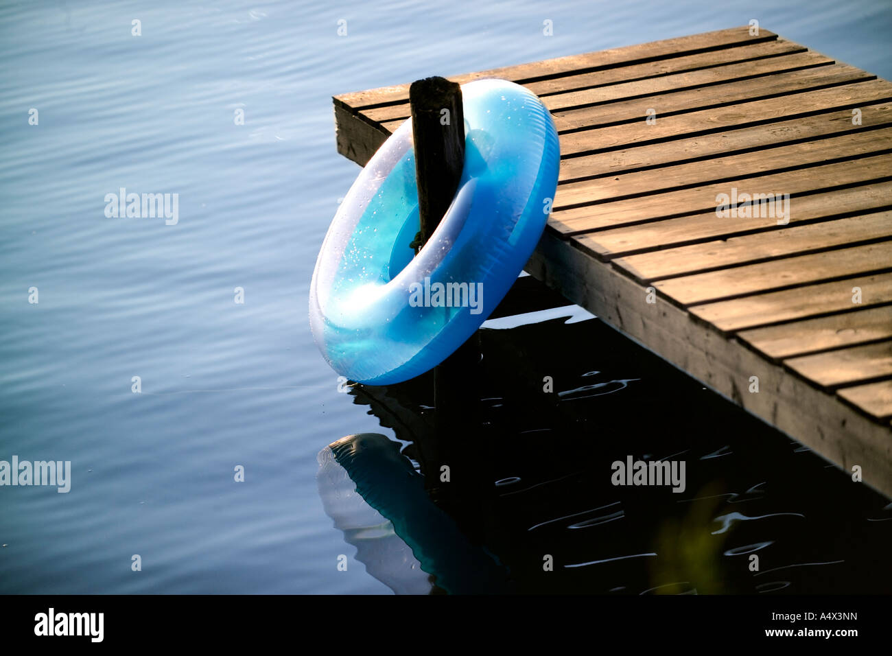 Dock and inner tube on a Lake Stock Photo - Alamy
