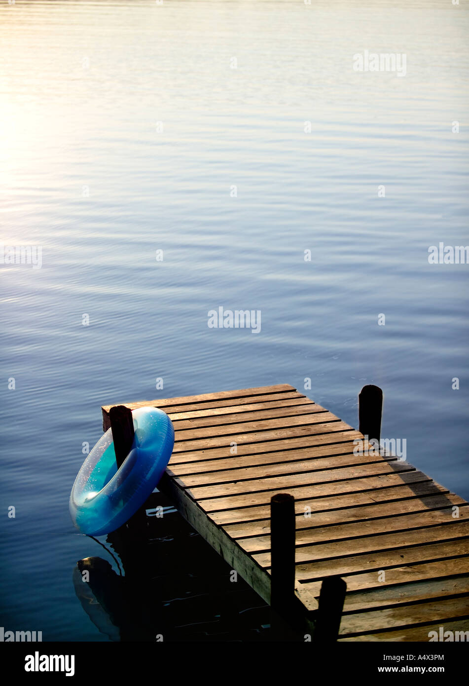 Dock and inner tube on a Lake Stock Photo - Alamy