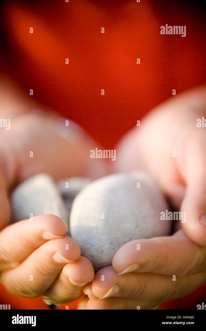 Hands holding stones Stock Photo - Alamy