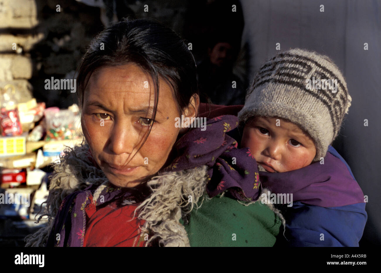 Woman carrying a baby on her back Stock Photo - Alamy