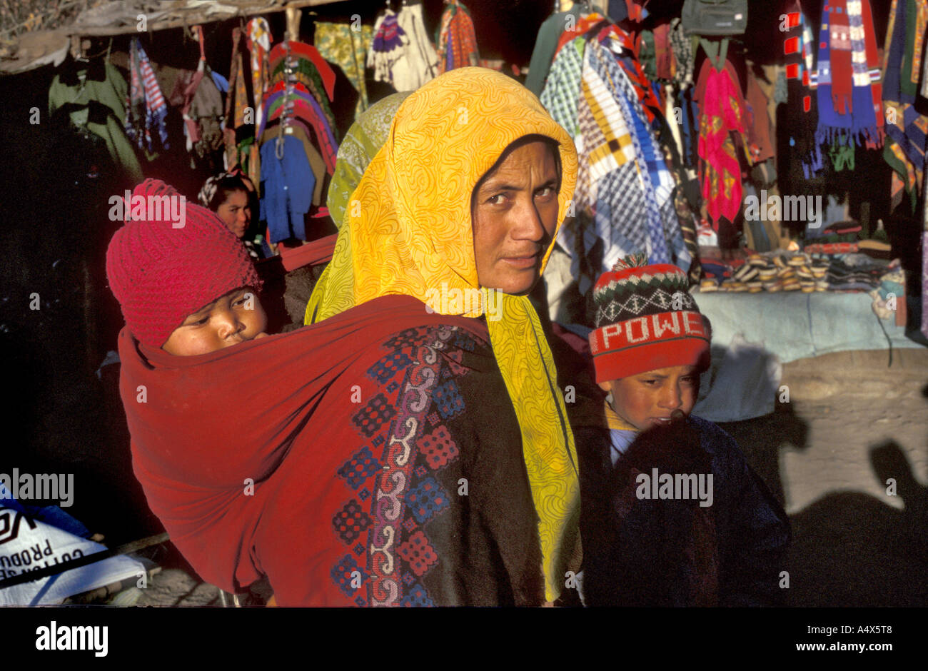 Woman carrying a baby on her back Stock Photo - Alamy
