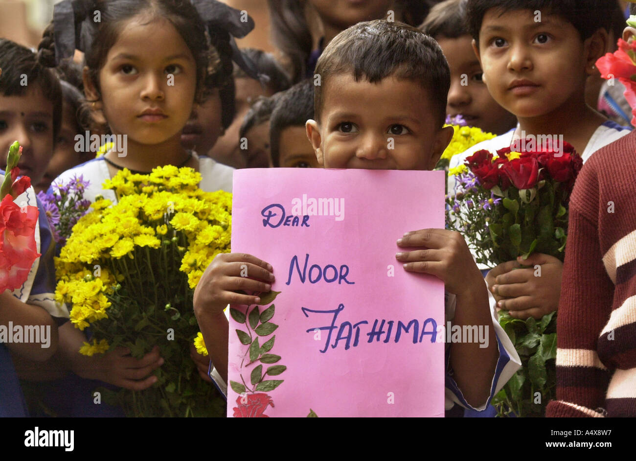 Children displaying welfare cards for Noor Fatima Banglore Kar Stock ...