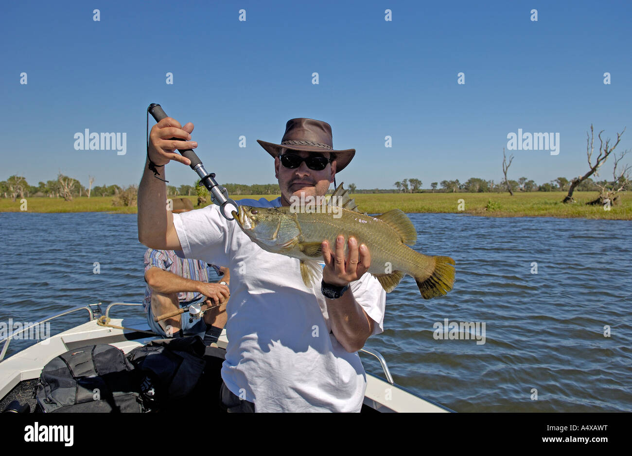 Tourist with catched fish, barramundi, Lates calcarifer, Northern ...