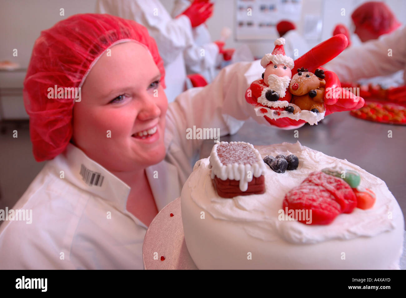 PRODUCTION LINE WORKERS ADDING THE FINISHING TOUCHES TO CHRISTMAS CAKES ...