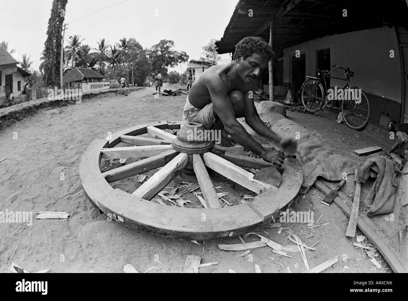Man repairing cart wheel Stock Photo - Alamy