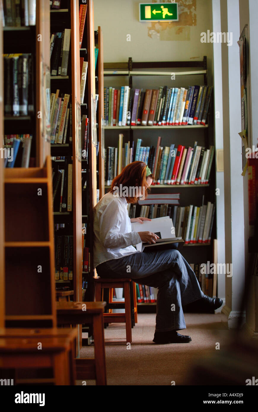 A STUDENT READING IN THE LIBRARY OF THE SOMERSET PLACE CAMPUS OF BATH ...