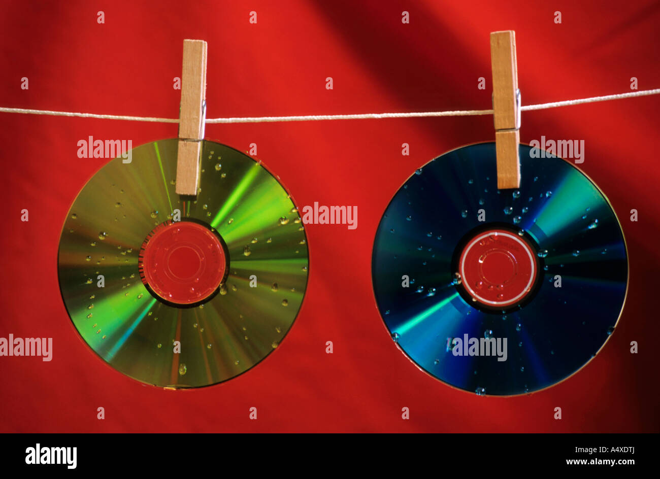 Two wet compact discs drying on a washing line Stock Photo - Alamy