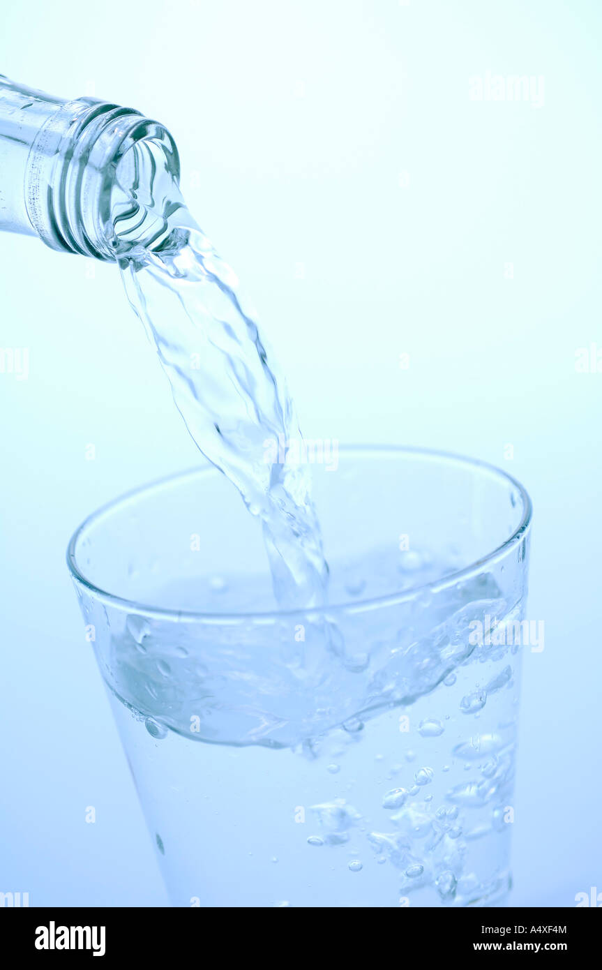 Pouring mineral water into a glass Stock Photo - Alamy