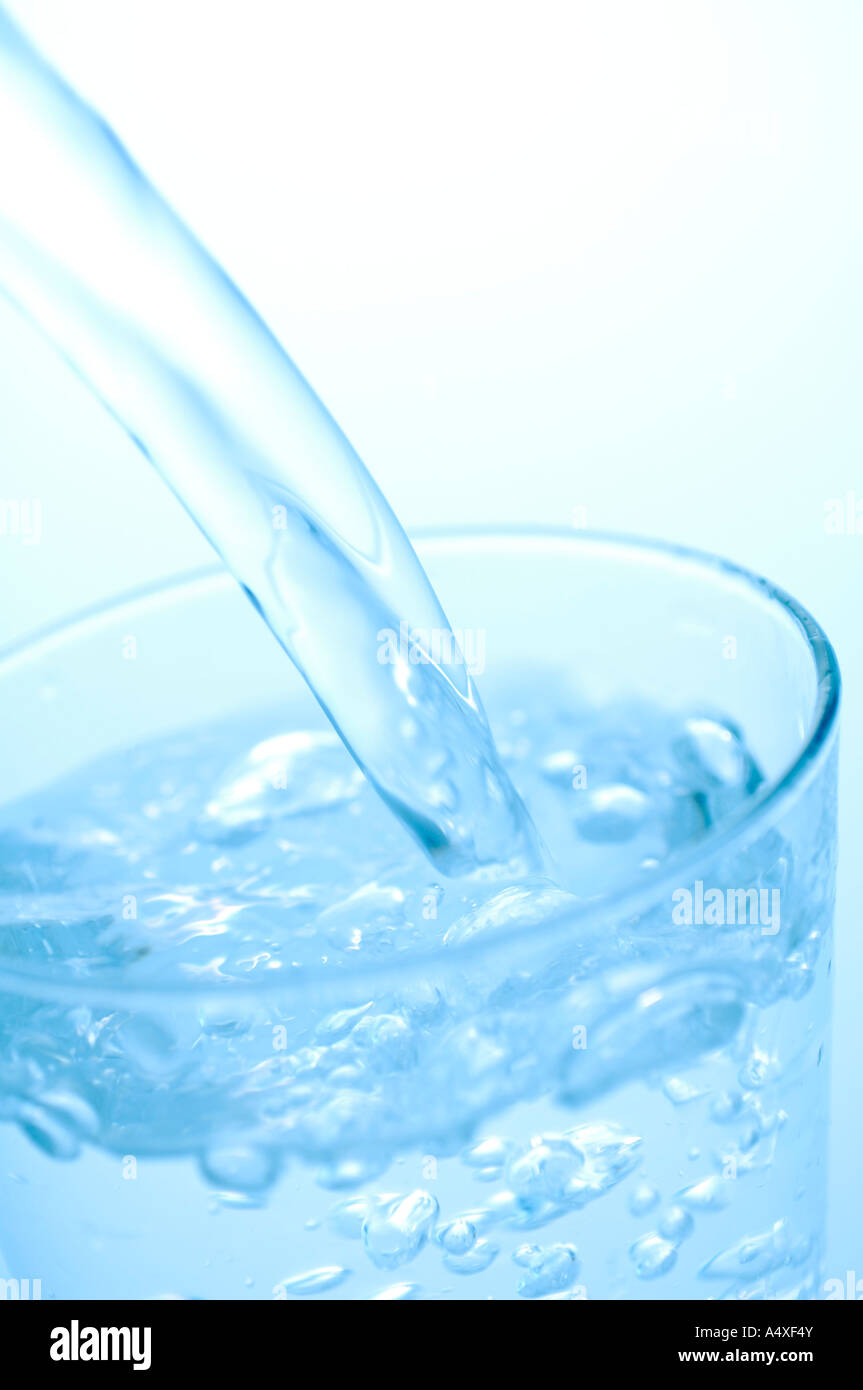 Pouring mineral water into a glass Stock Photo - Alamy