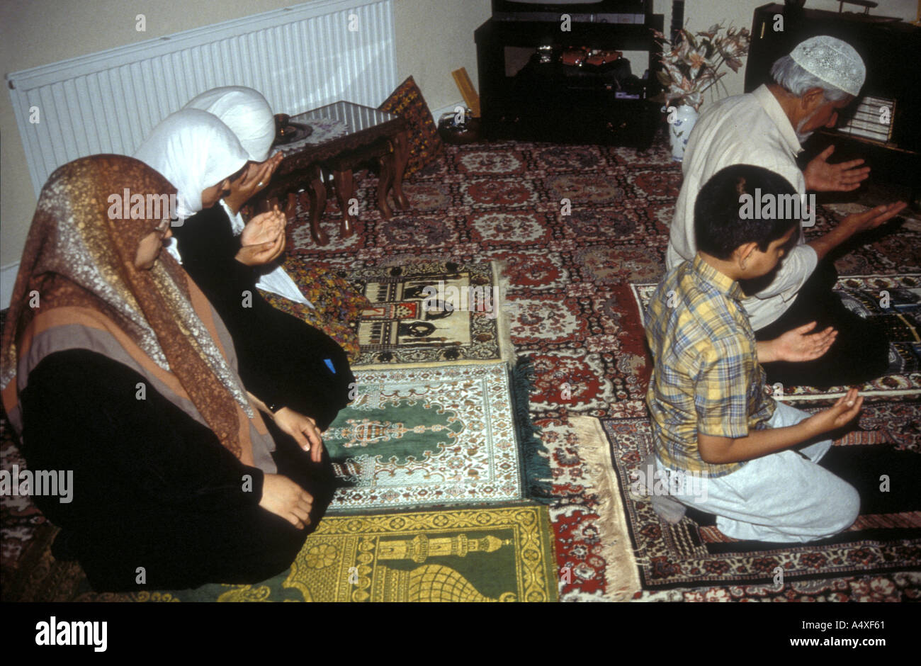 A Muslim family prays at home together N London Stock Photo - Alamy