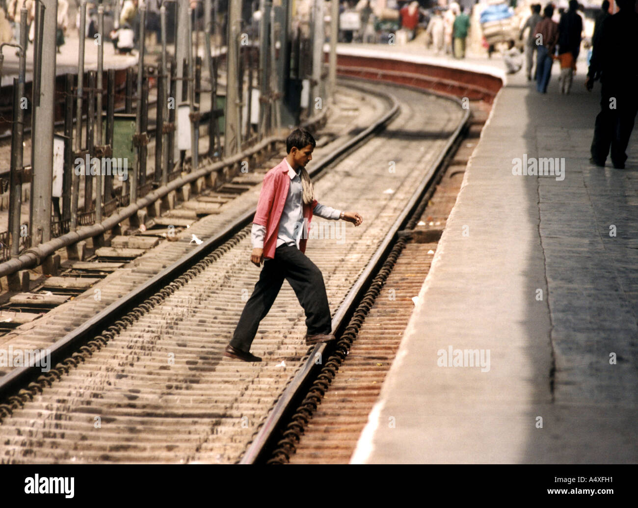 Man crossing the railway track Stock Photo - Alamy