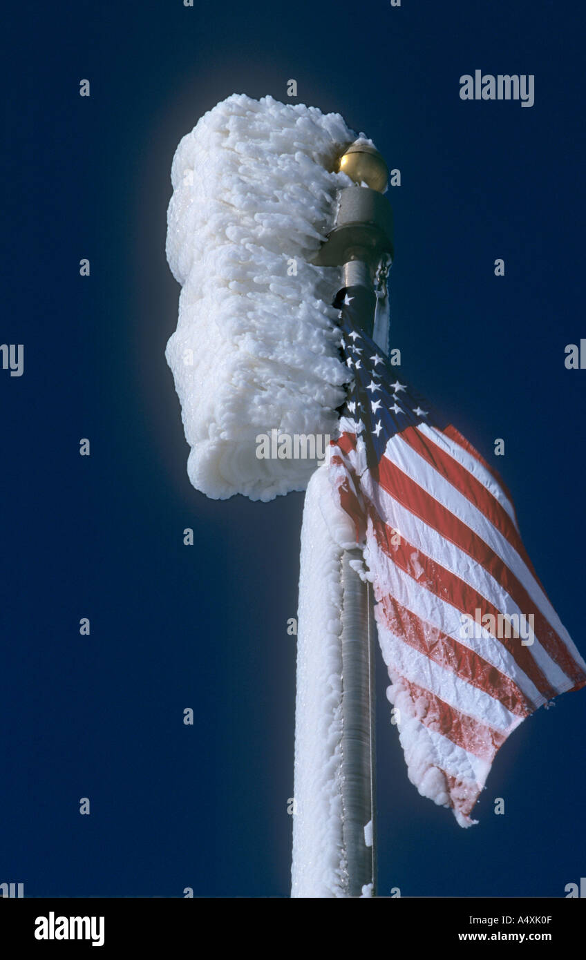 A block of ice grows around the flag of the USA on a flagpole at Niagra ...