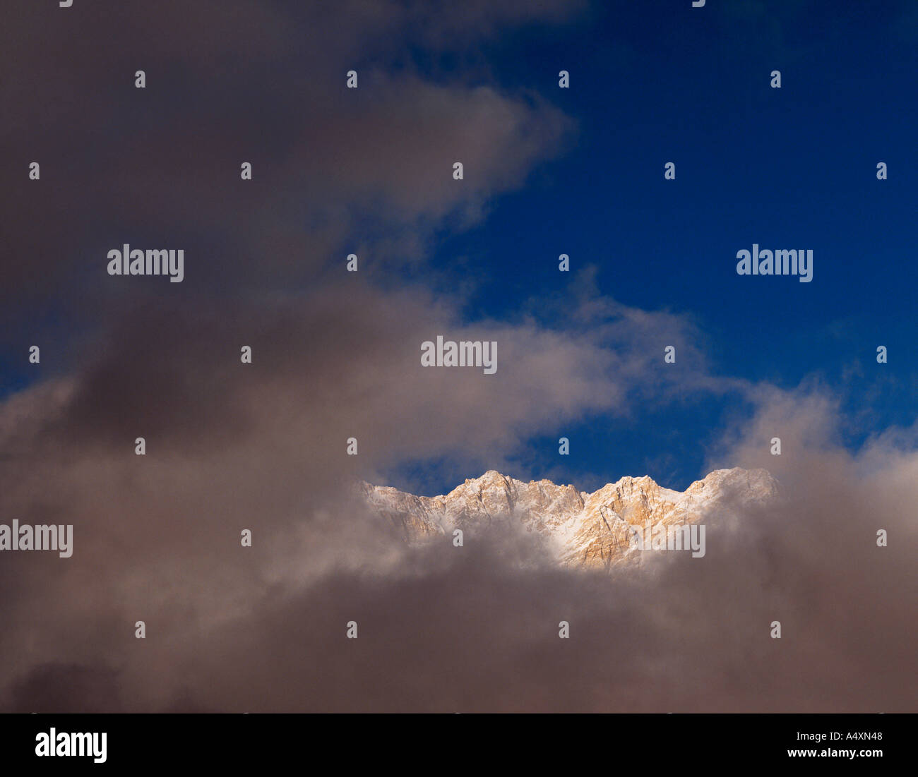 The summit of Kangchenjunga glimpsed through cloud from near the ...