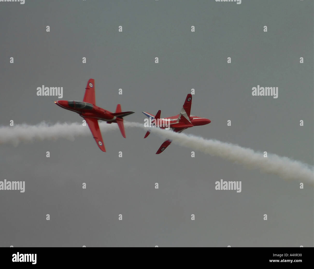 RAF Red Arrows two planes cross Stock Photo - Alamy