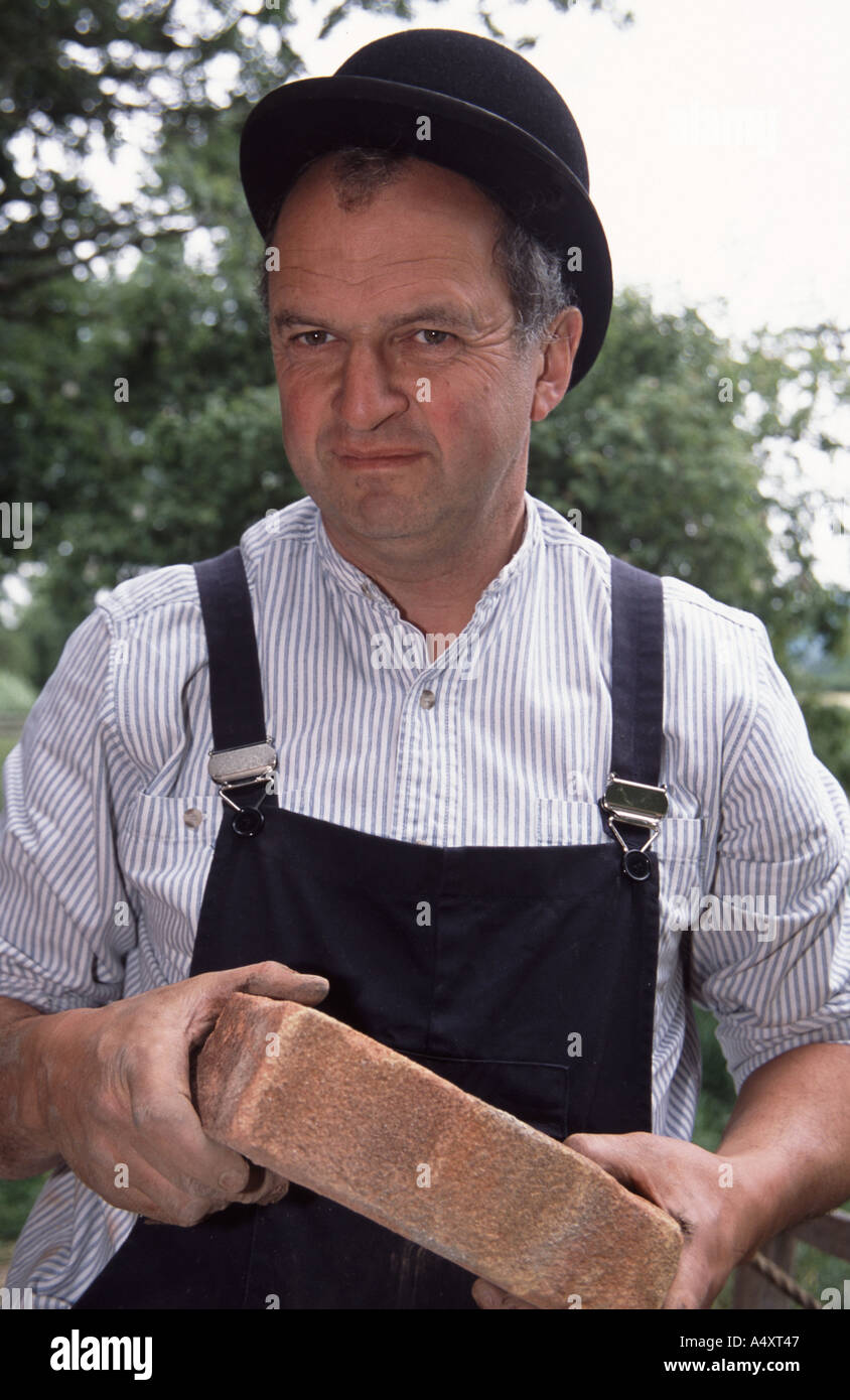 Colin Richards making bricks by hand with a finished one Stock Photo ...