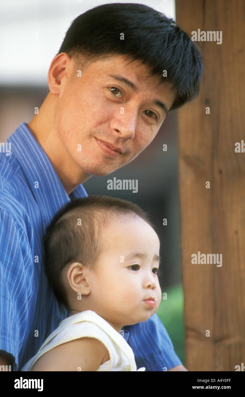 Young Asian Father Holding His Son Stock Photo - Alamy