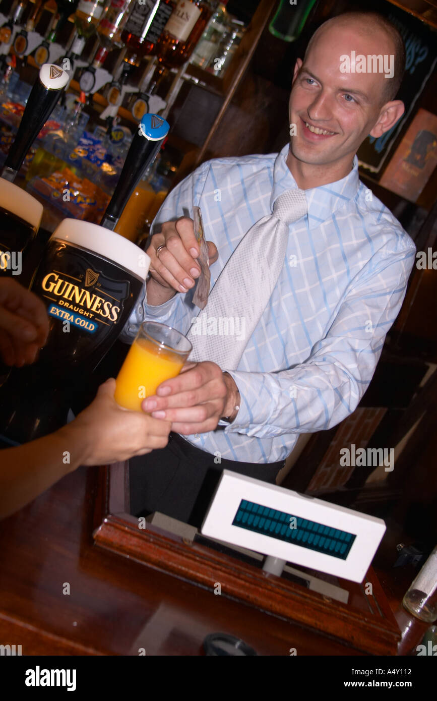 Smiling man paying bartender hi-res stock photography and images - Alamy