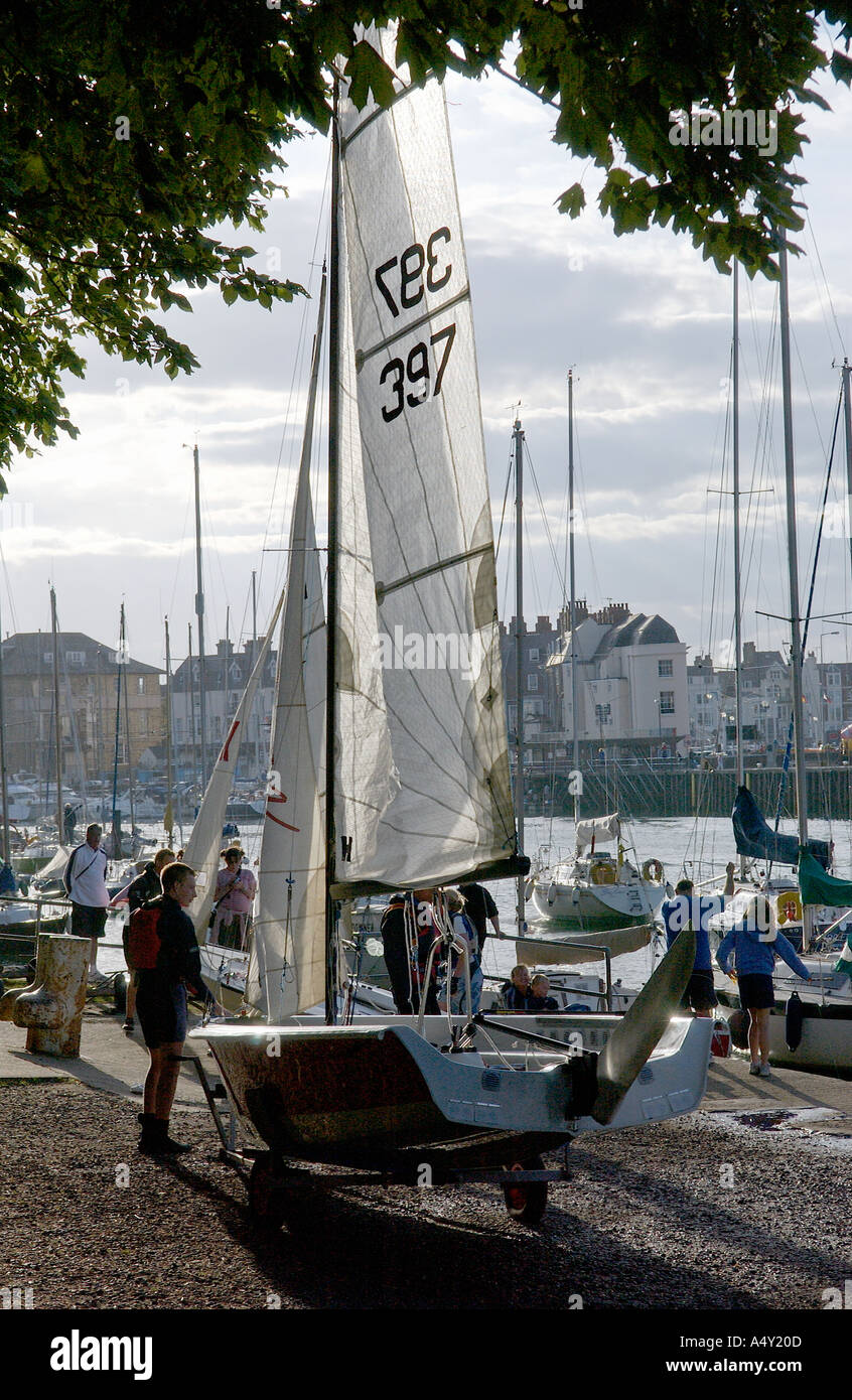 Rigging a sailing dinghy at Weymouth Harbour in Dorset England UK Stock ...