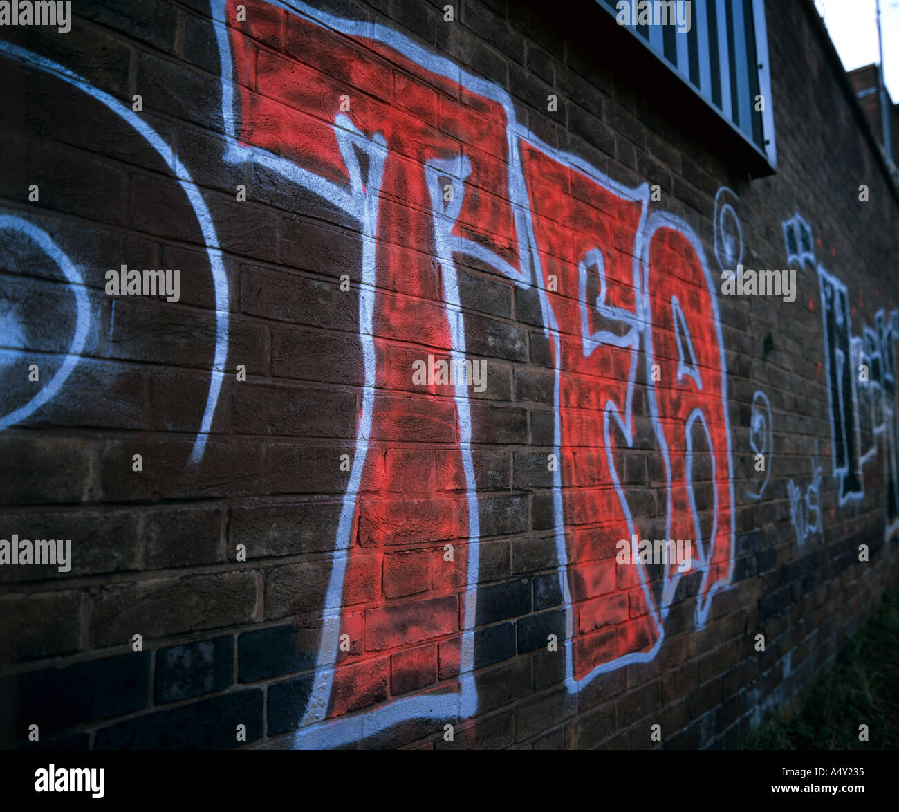Graffiti on a brick wall from a side angle Stock Photo - Alamy