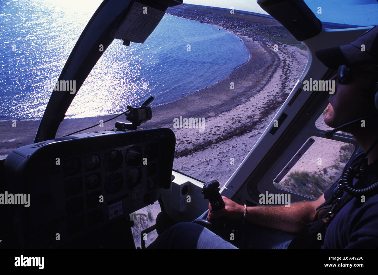 Helicopter pilot flying over tidal planes Arctic Hudson Bay Churchill ...