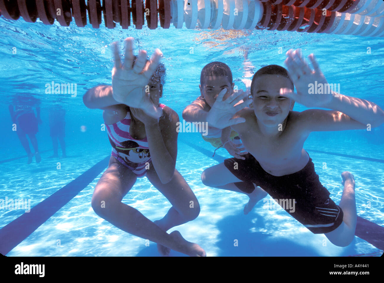 Kids playing underwater in a swimming pool New York United States Kike ...