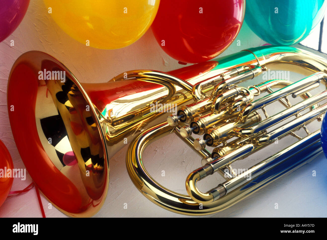 Tuba in window with party balloons Stock Photo - Alamy